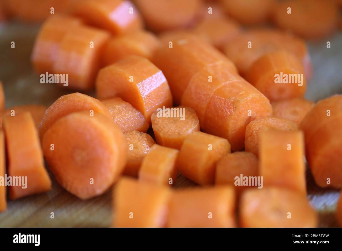 Carrot cut in slices on a board Stock Photo - Alamy