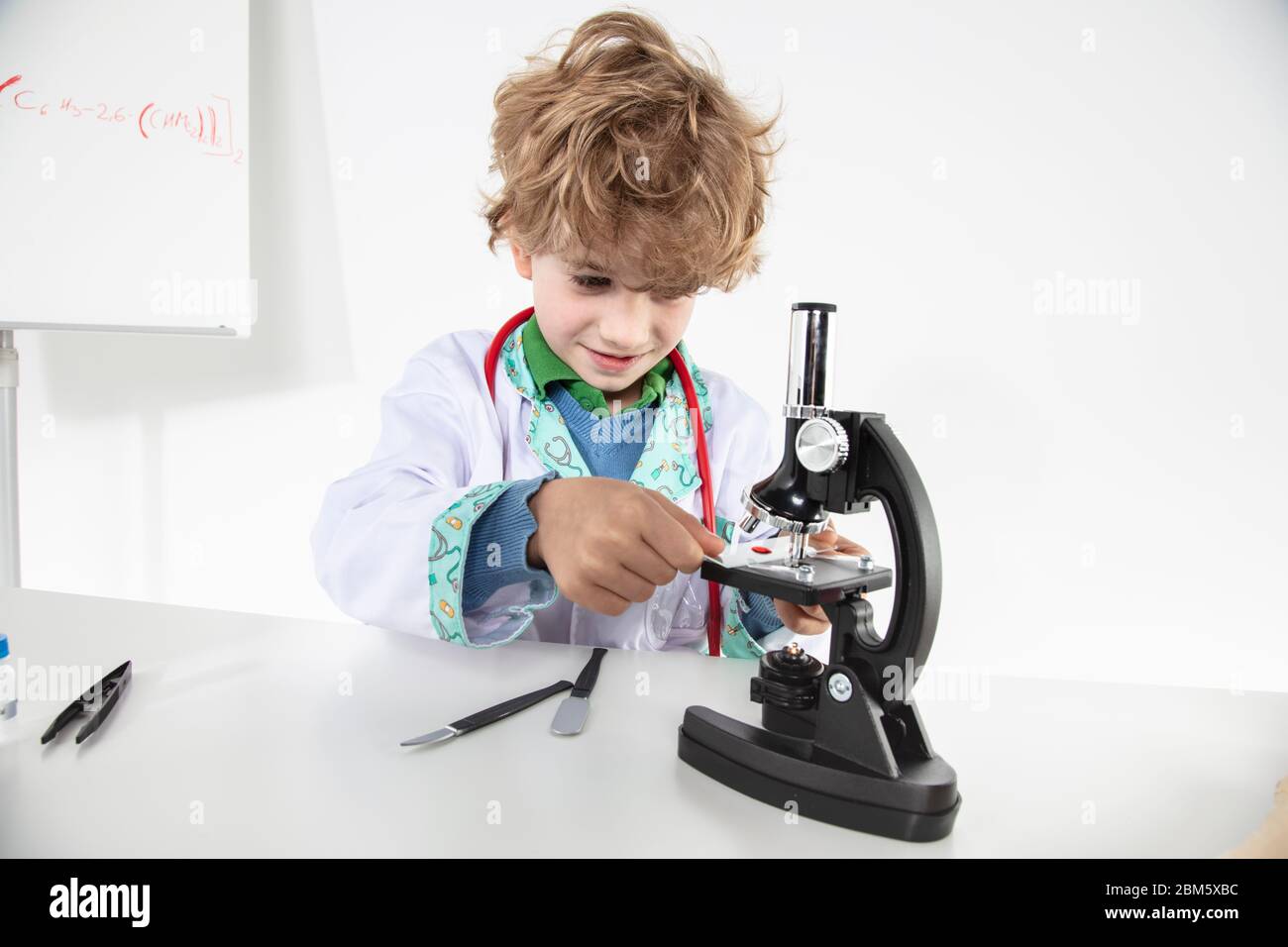 young doctor sitting over a microscope in his laboratory Stock Photo ...