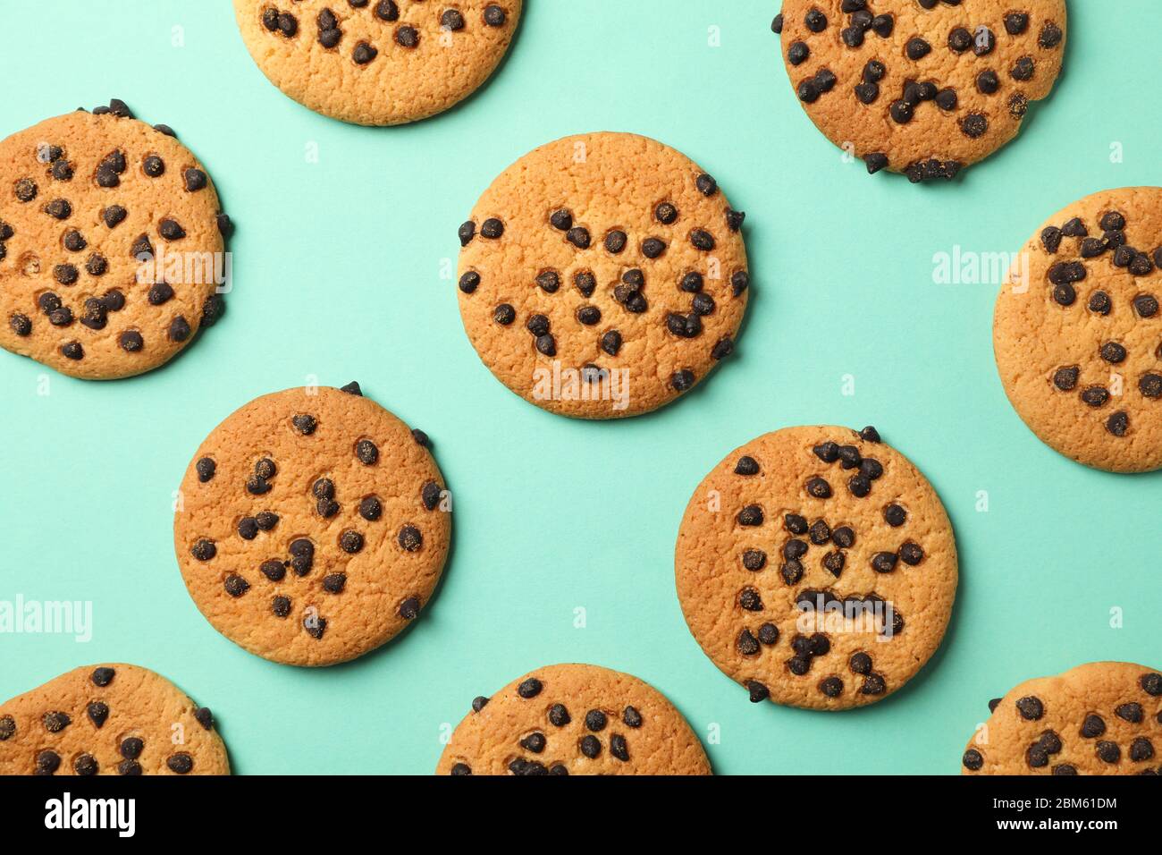 Flat lay with chocolate chip cookies on mint background Stock Photo - Alamy