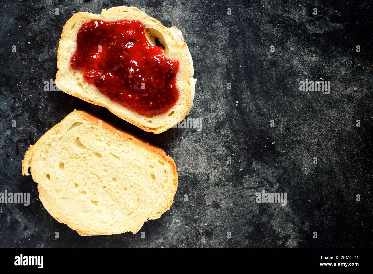 Sandwich with raspberry jam. Sandwich on a dark background isolated ...