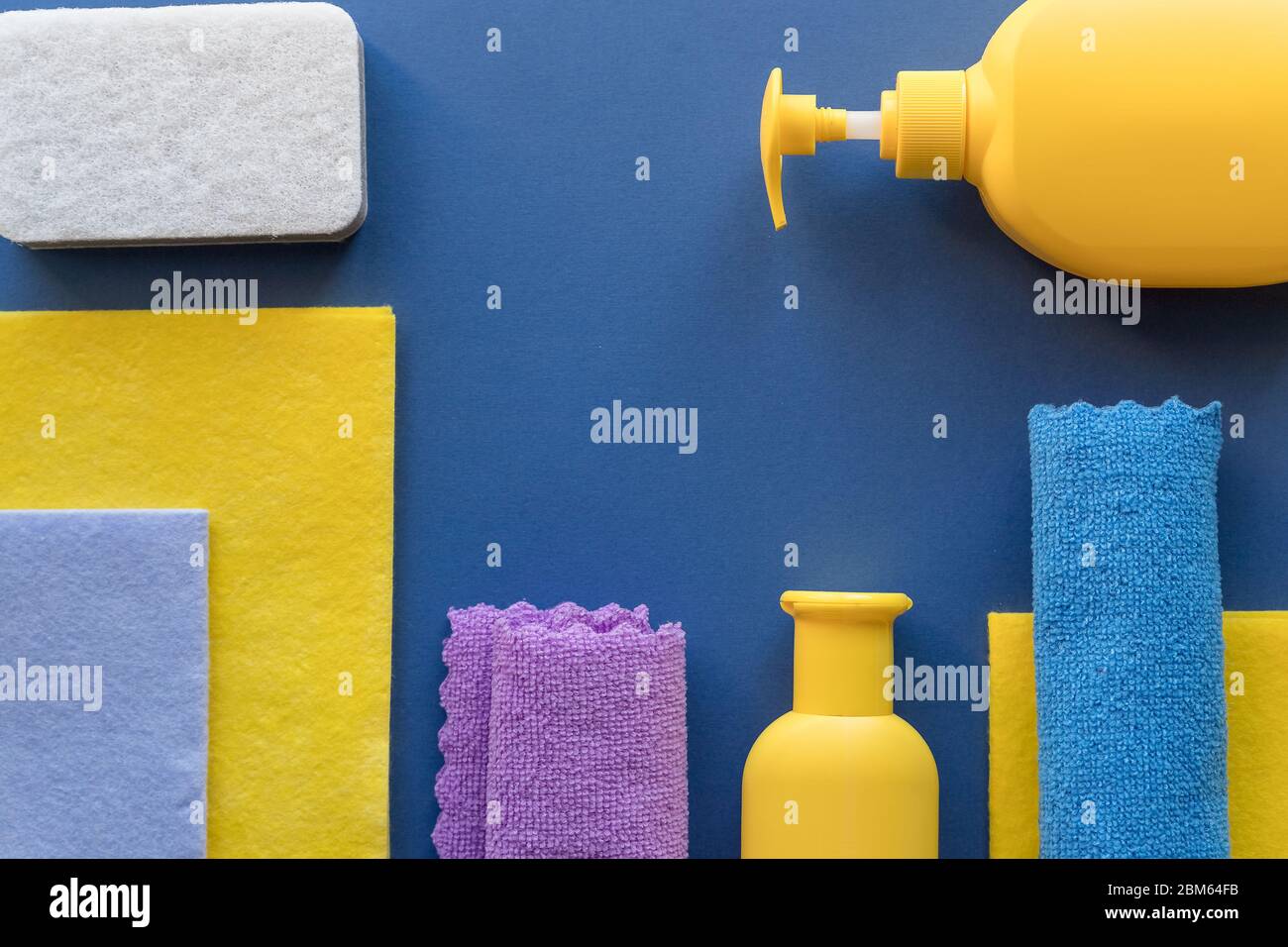 Colorful cleaning set for different surfaces on blue background ...