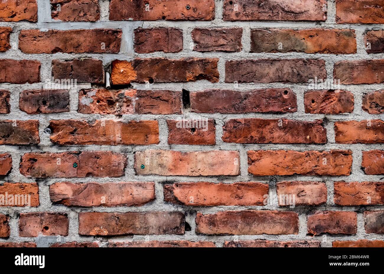 Close up view at an aged and weathered red brick wall at historical ...