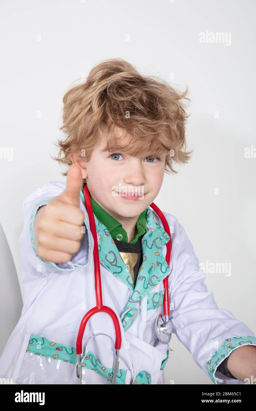 busy young doctor shows thumbs up, a symbol of good luck Stock Photo ...