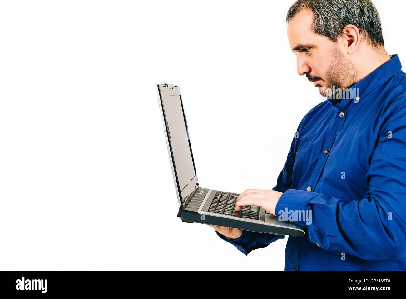 man holding a laptop on a white background Stock Photo - Alamy