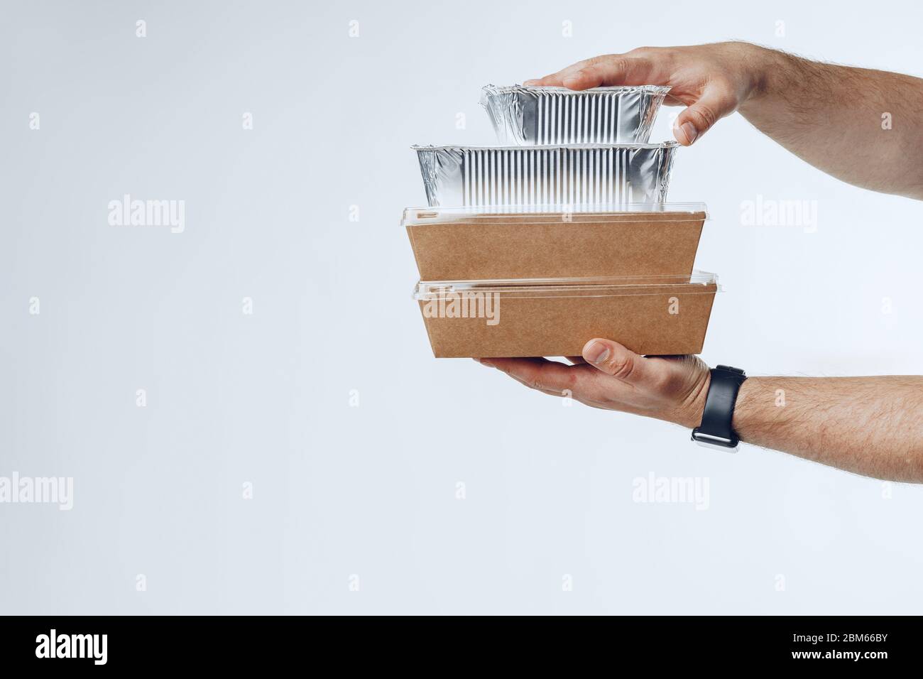 Courier hands giving packed food delivery close up Stock Photo - Alamy