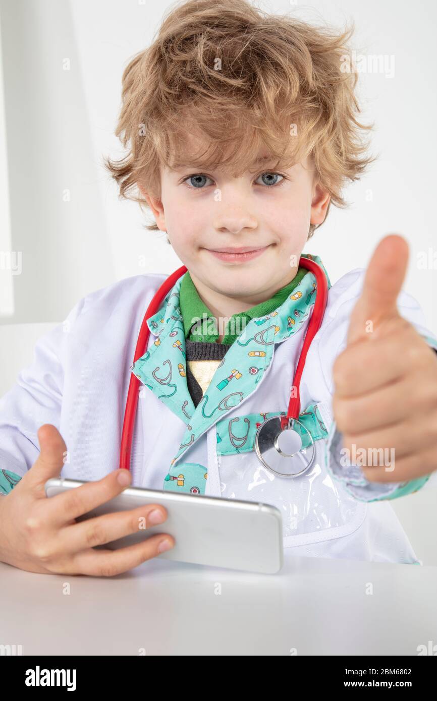 busy young doctor shows thumbs up, a symbol of good luck Stock Photo ...