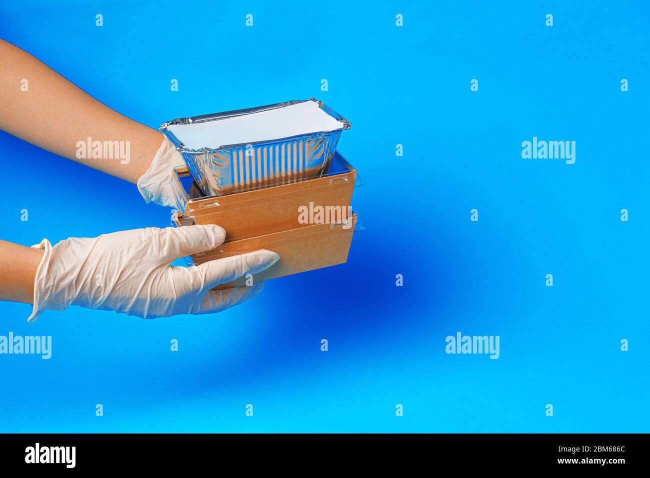 Delivery man hands giving food containers and packages Stock Photo - Alamy