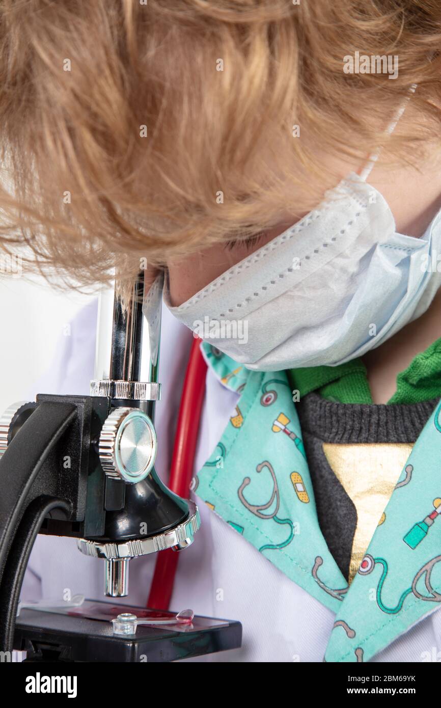 young doctor sitting over a microscope in his laboratory Stock Photo ...
