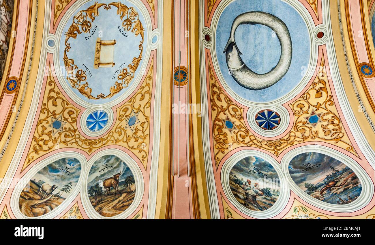 Open scroll of the Torah and Leviathan swallowing its own tail, murals ...