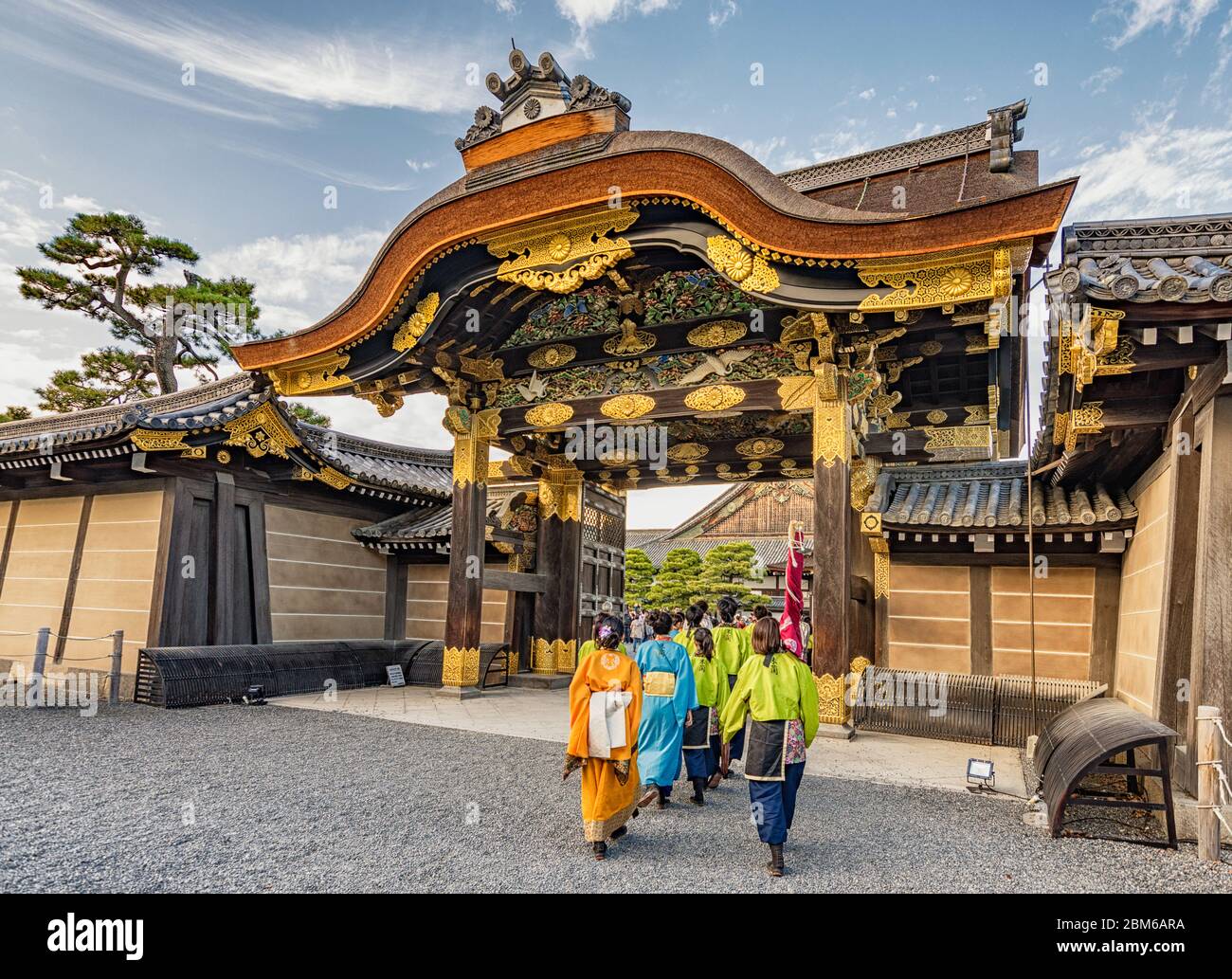People wearing traditional Japanese clothing entering gate of shogun ...