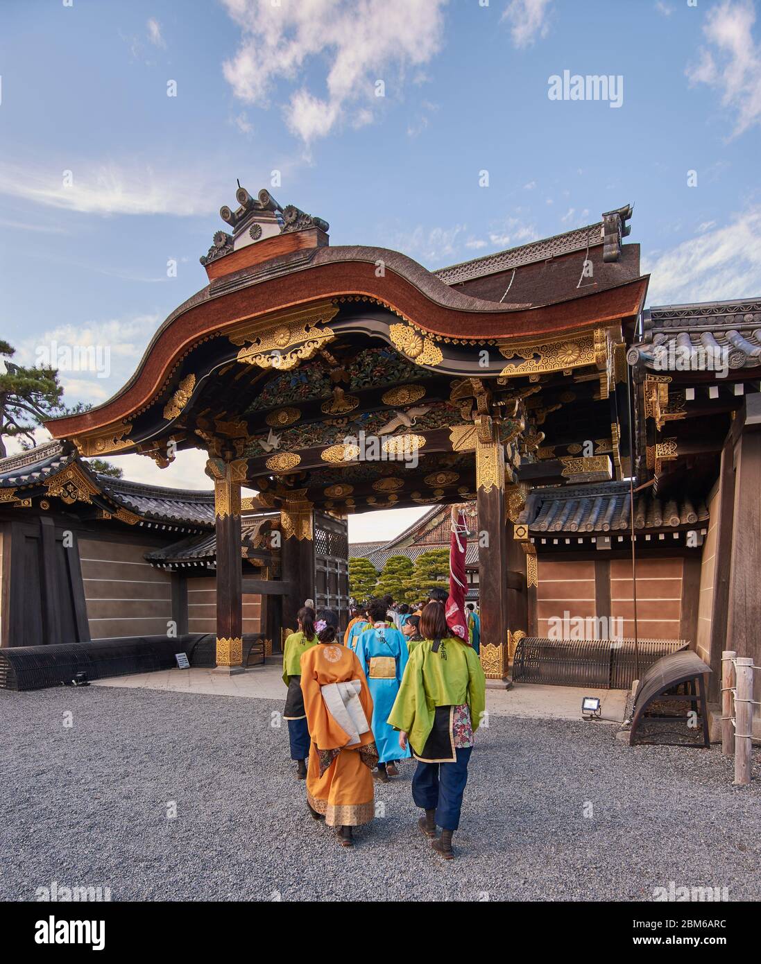 People wearing traditional Japanese clothing entering gate of shogun ...