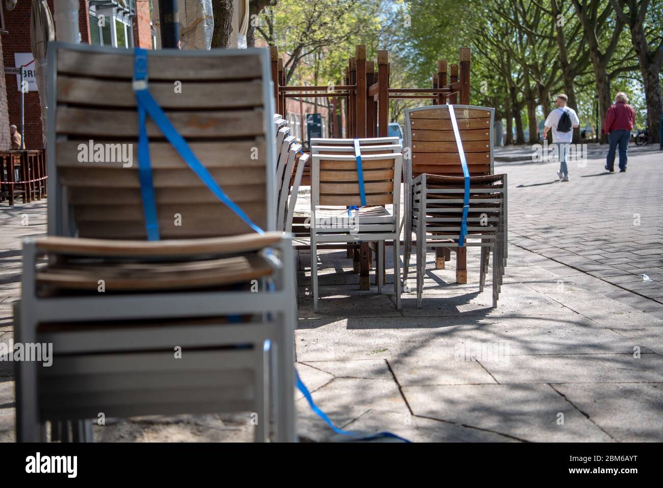 Bremen, Germany. 07th May, 2020. Tied up chairs stand in front of a ...