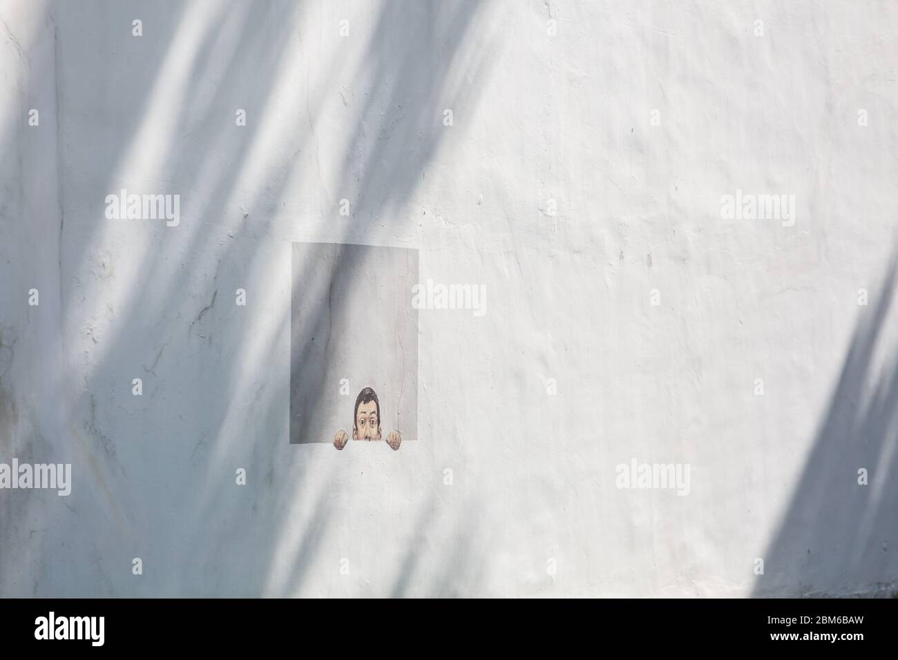 Street art drawing of a boy looking out of a square window. Singapore ...