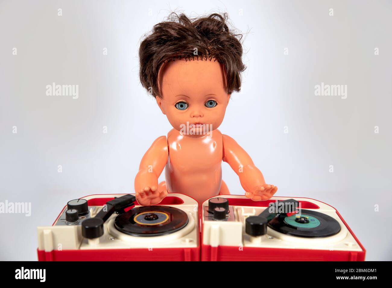 Toy plastic doll DJ playing vinyl on the decks Stock Photo - Alamy