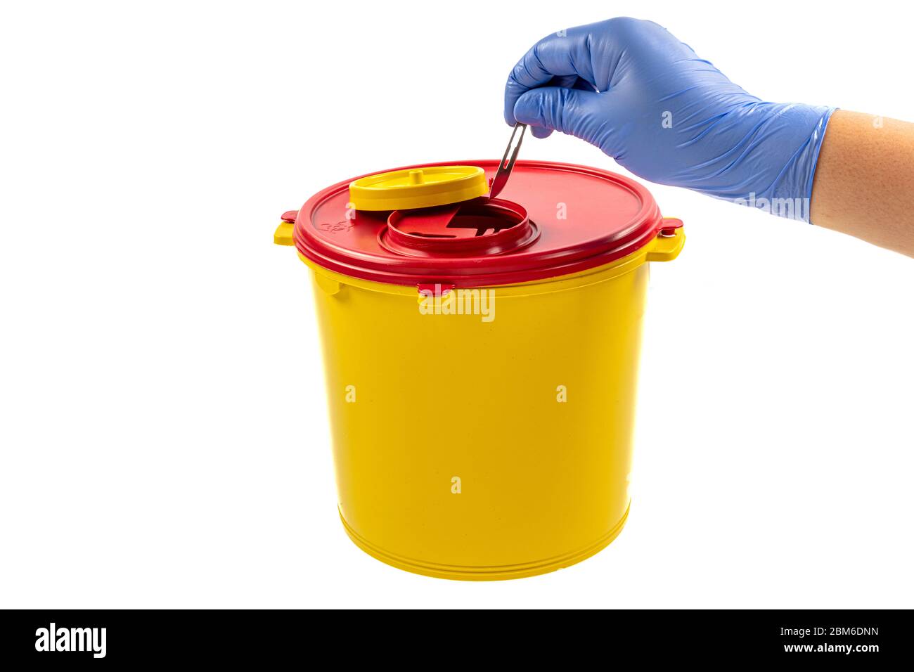 Closeup of hand depositing a used lancet on waste needle container ...