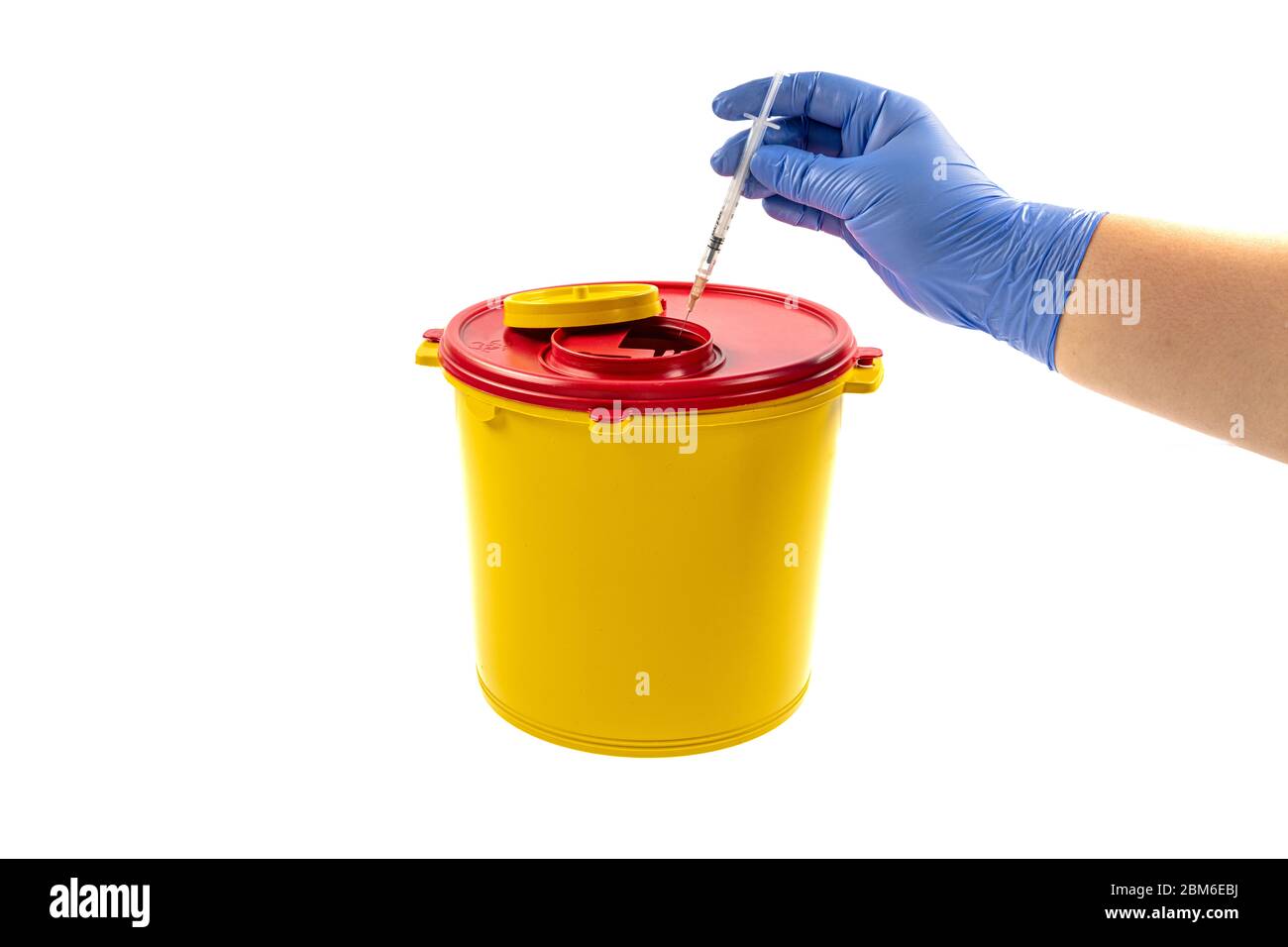 Closeup of hand depositing a used lancet on waste needle container ...