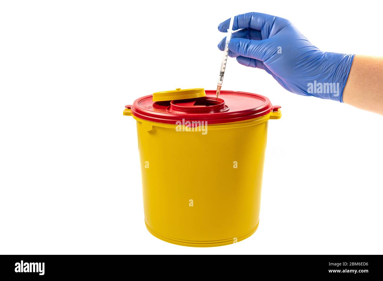 Closeup of hand depositing a used lancet on waste needle container ...