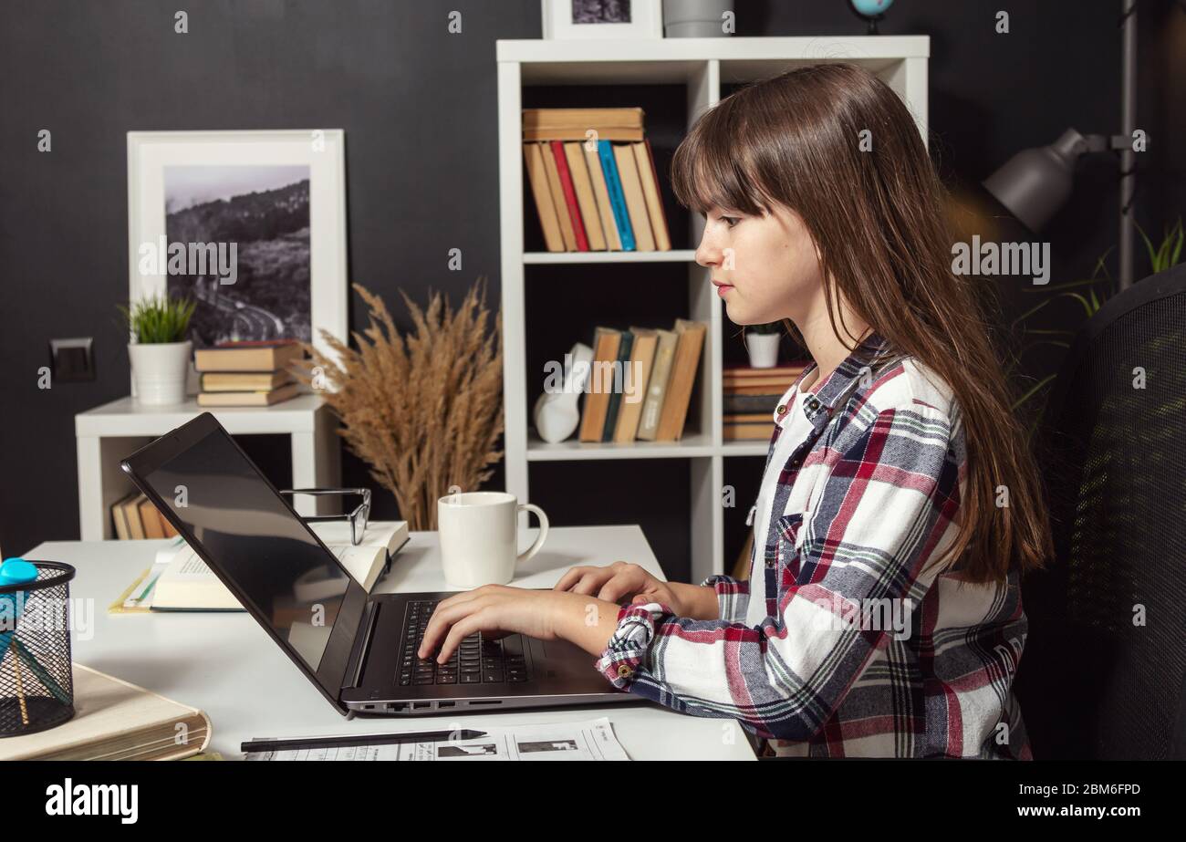 Female teenager studying from home Stock Photo - Alamy