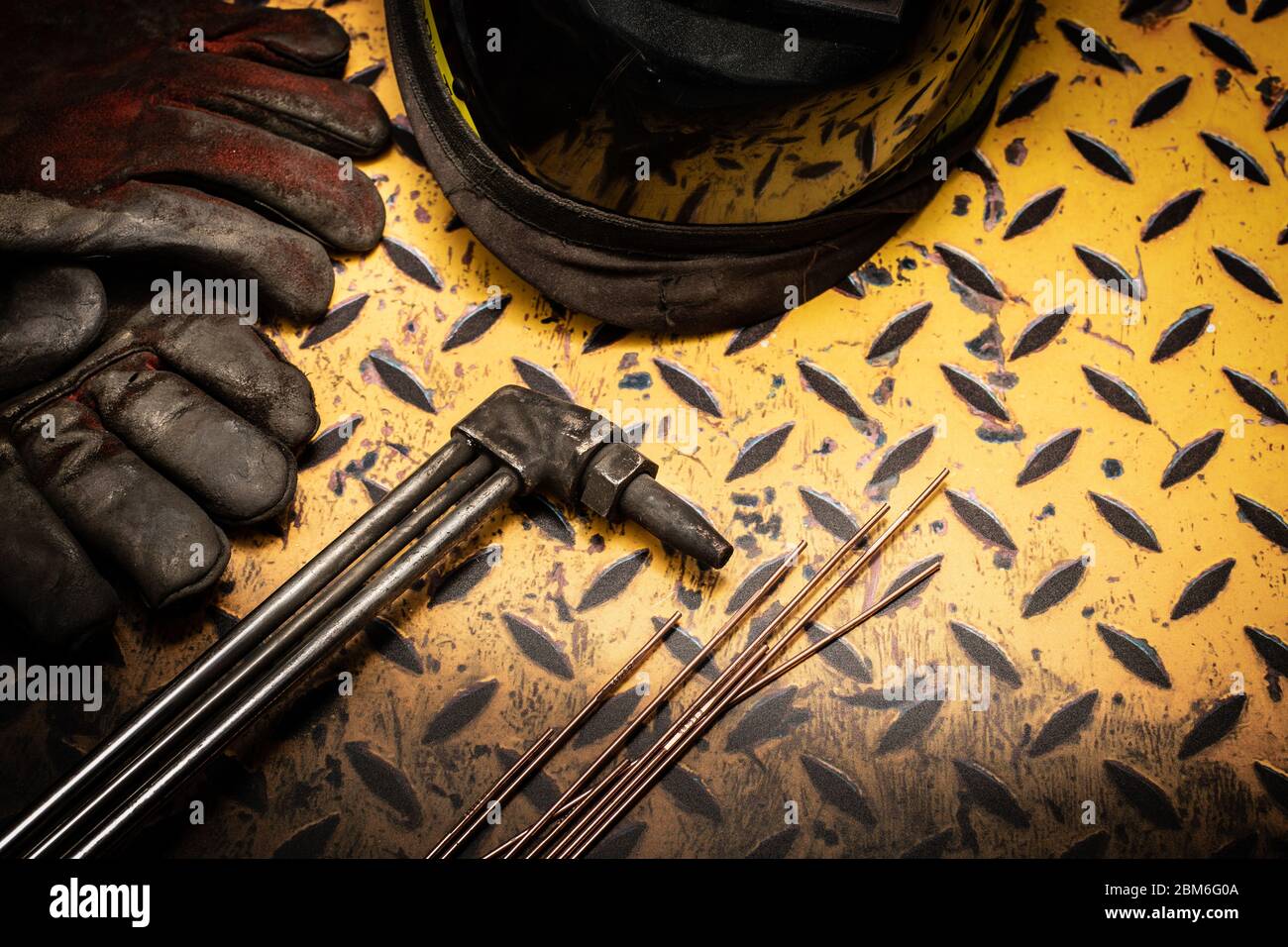 Gas welding and safety equipment on a grunge yellow checkerplate ...