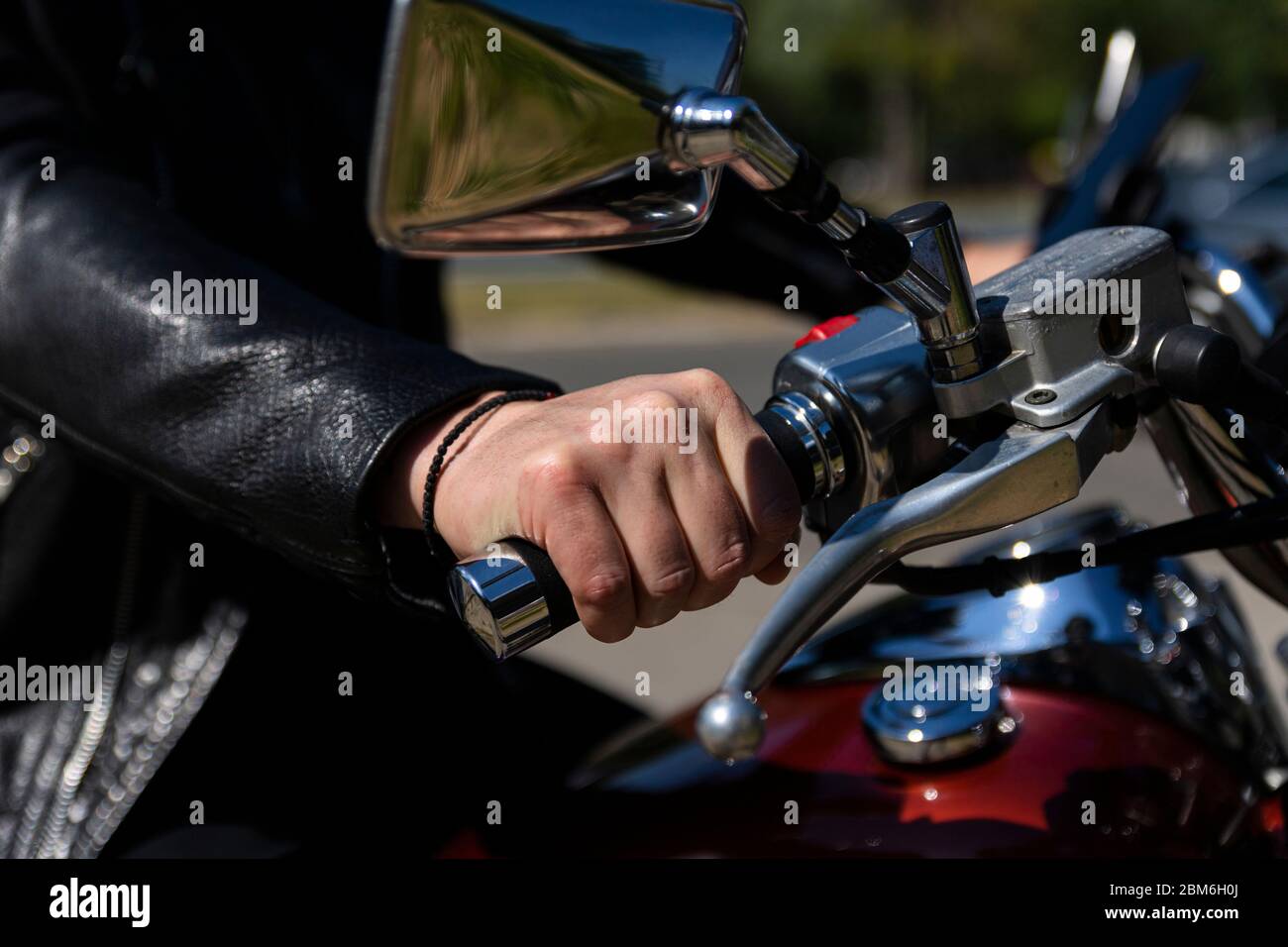 Biker riding on a motorcycle. View of a hand on handlebar giving gas ...