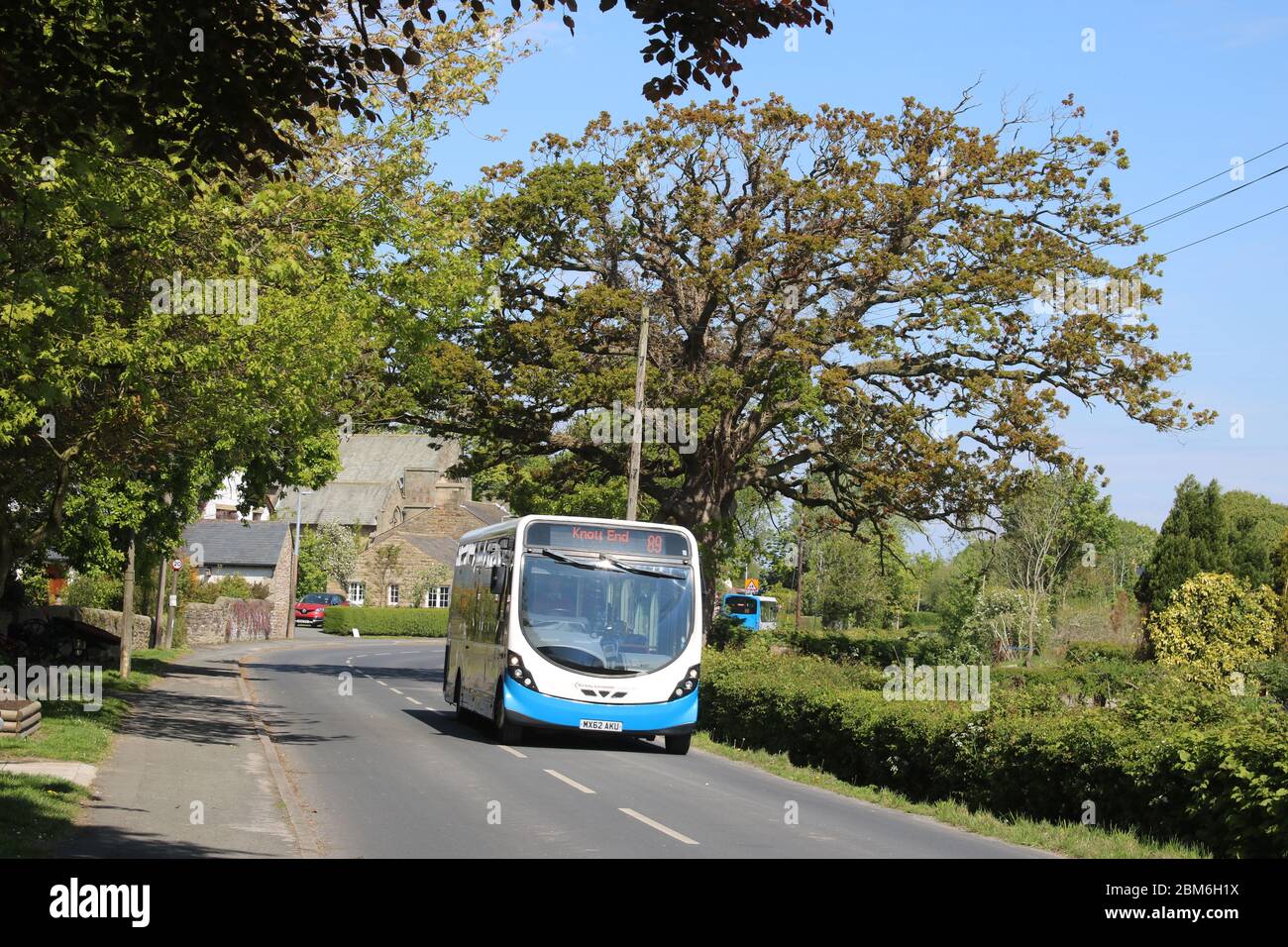 Single deck bus on rural bus service passing through Pilling village ...