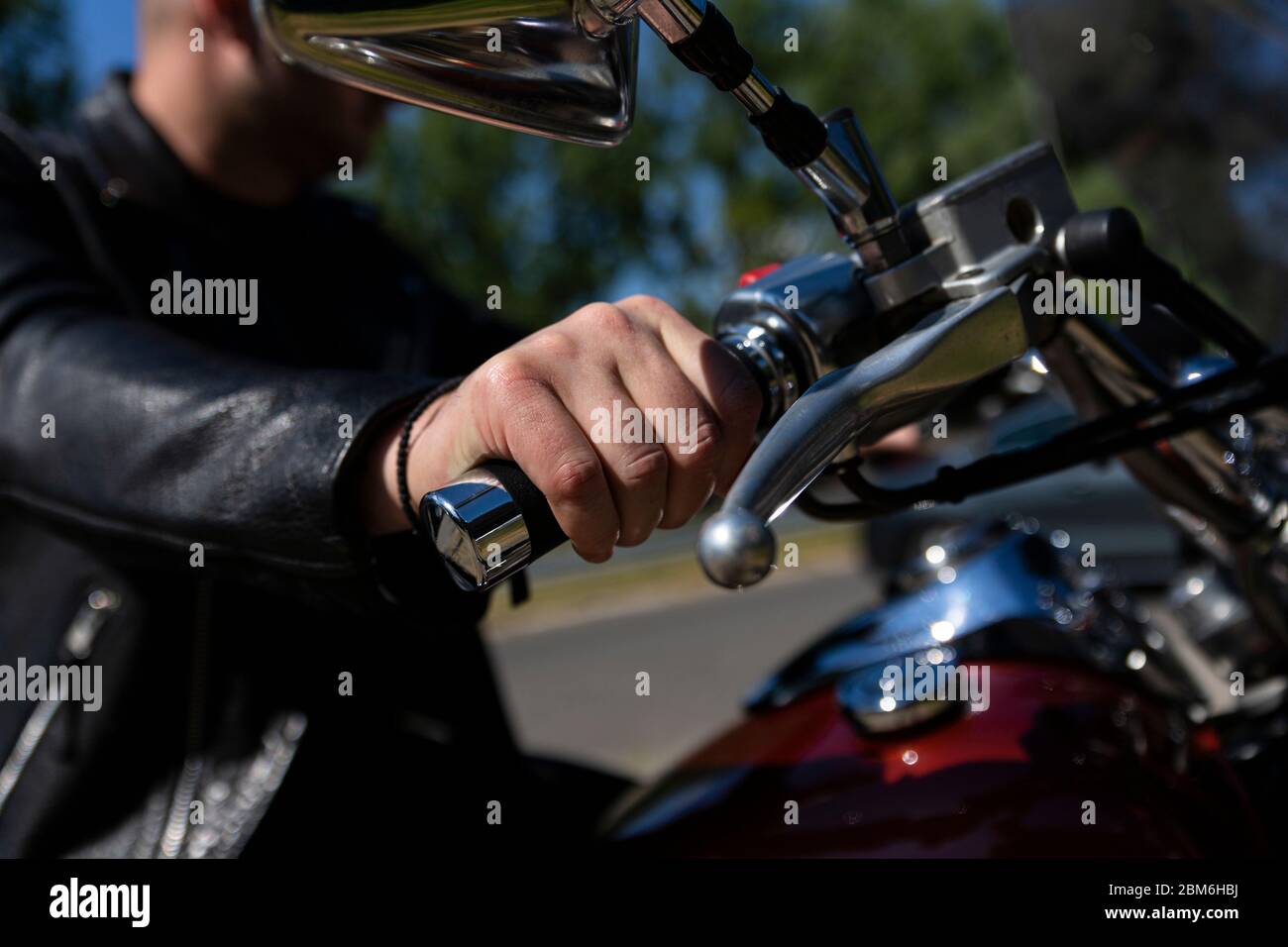 Biker riding on a motorcycle. View of a hand on handlebar giving gas ...
