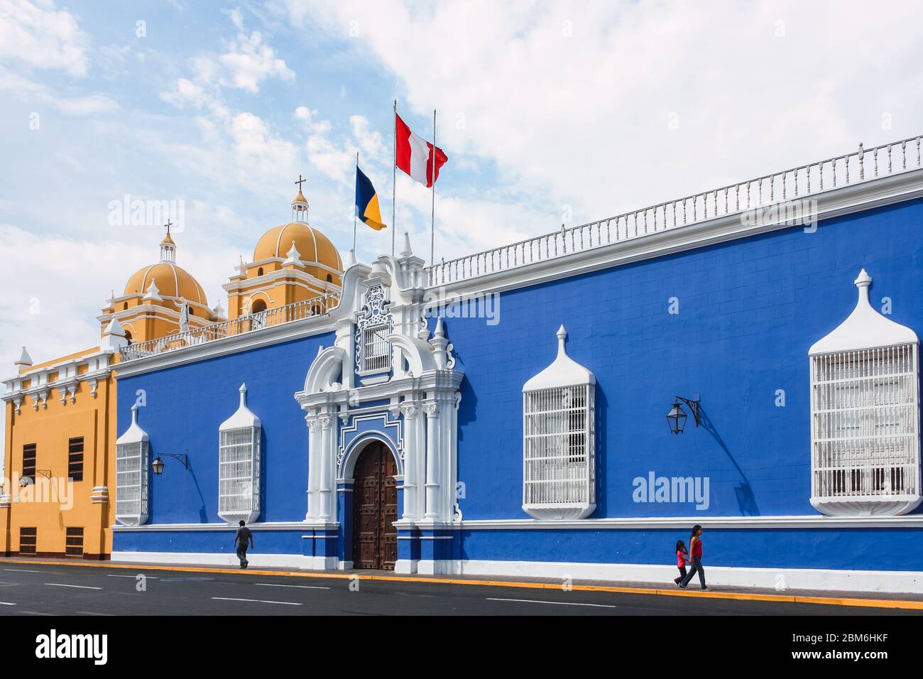 Trujillo, Peru; March 5 2011: Several people walk by the facade of a ...