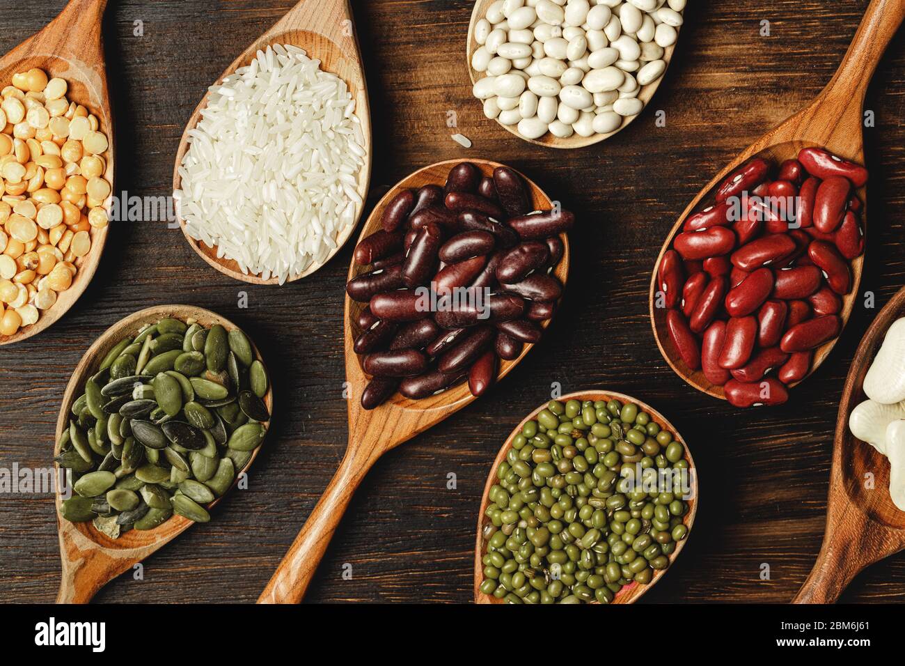 dried beans in wooden spoons on the table Stock Photo - Alamy