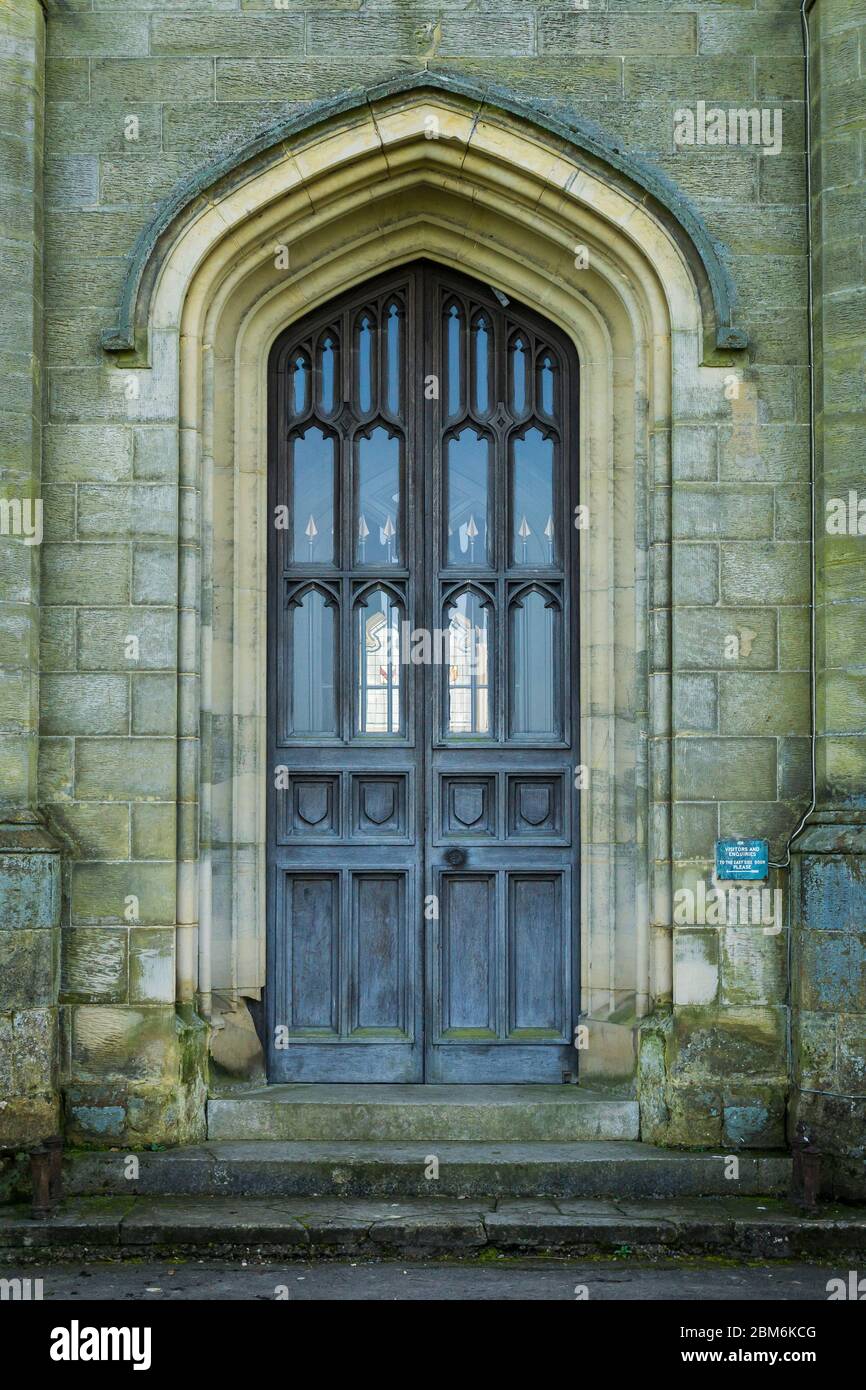 Arched wooden door at Kent 19th century English castle at Chiddingstone ...