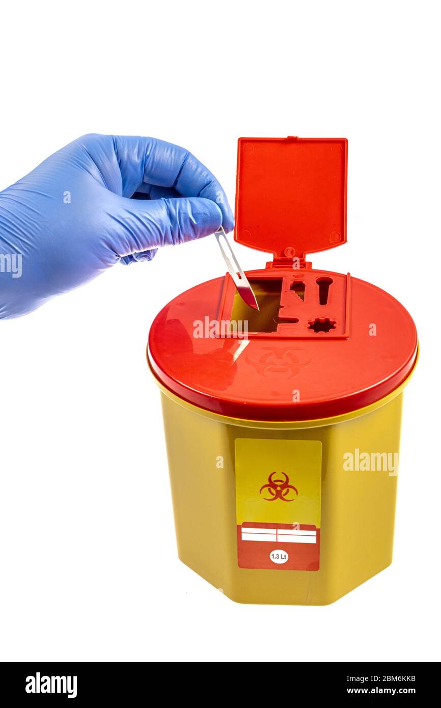 Health worker throws sharp waste into the medical waste bin. Medical ...