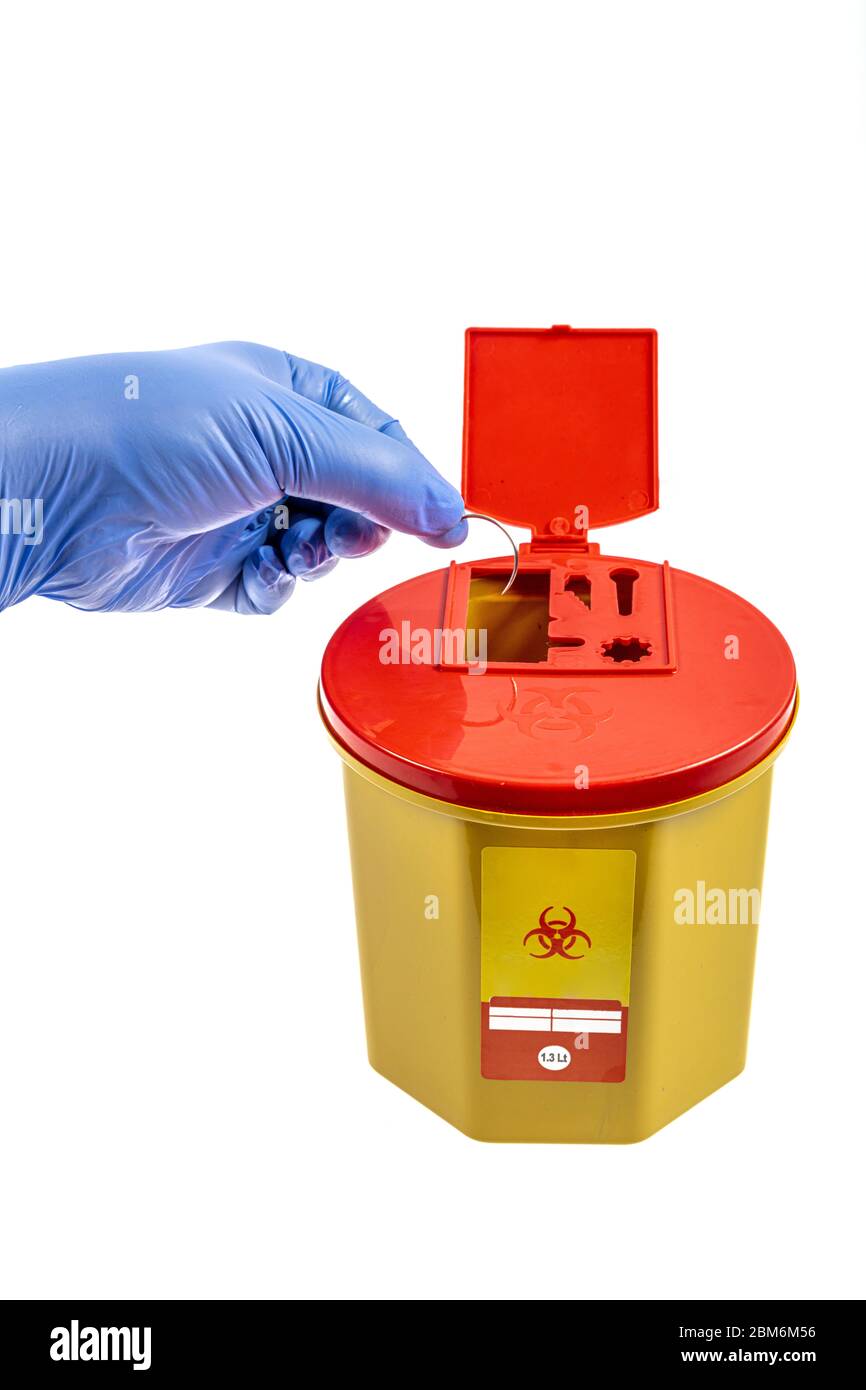 Health worker throws sharp waste into the medical waste bin. Medical ...