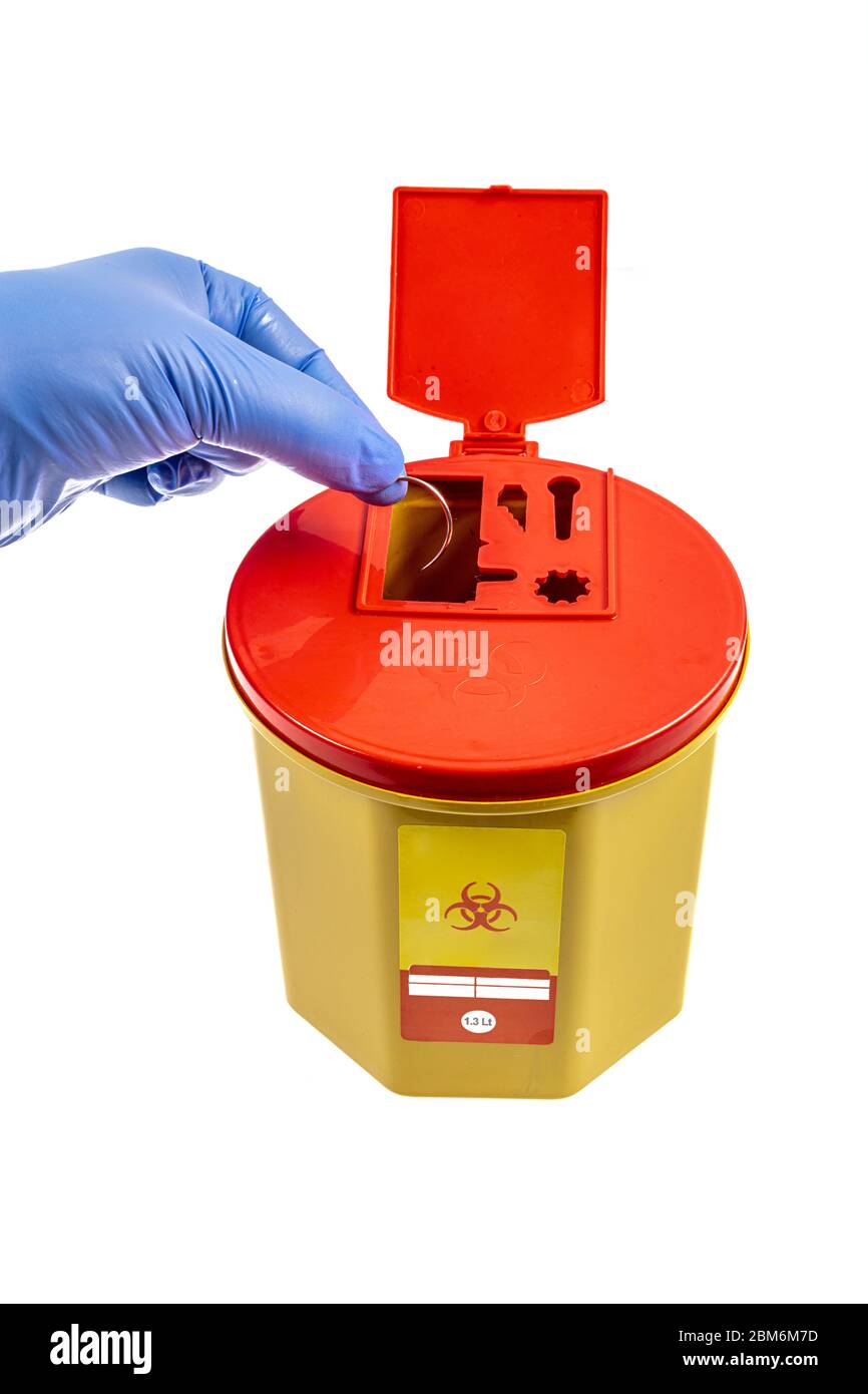 Health worker throws sharp waste into the medical waste bin. Medical ...