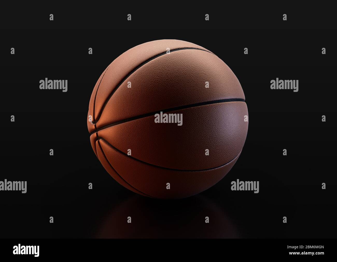A regulation orange and black rubber basketball in dramatic lighting on ...