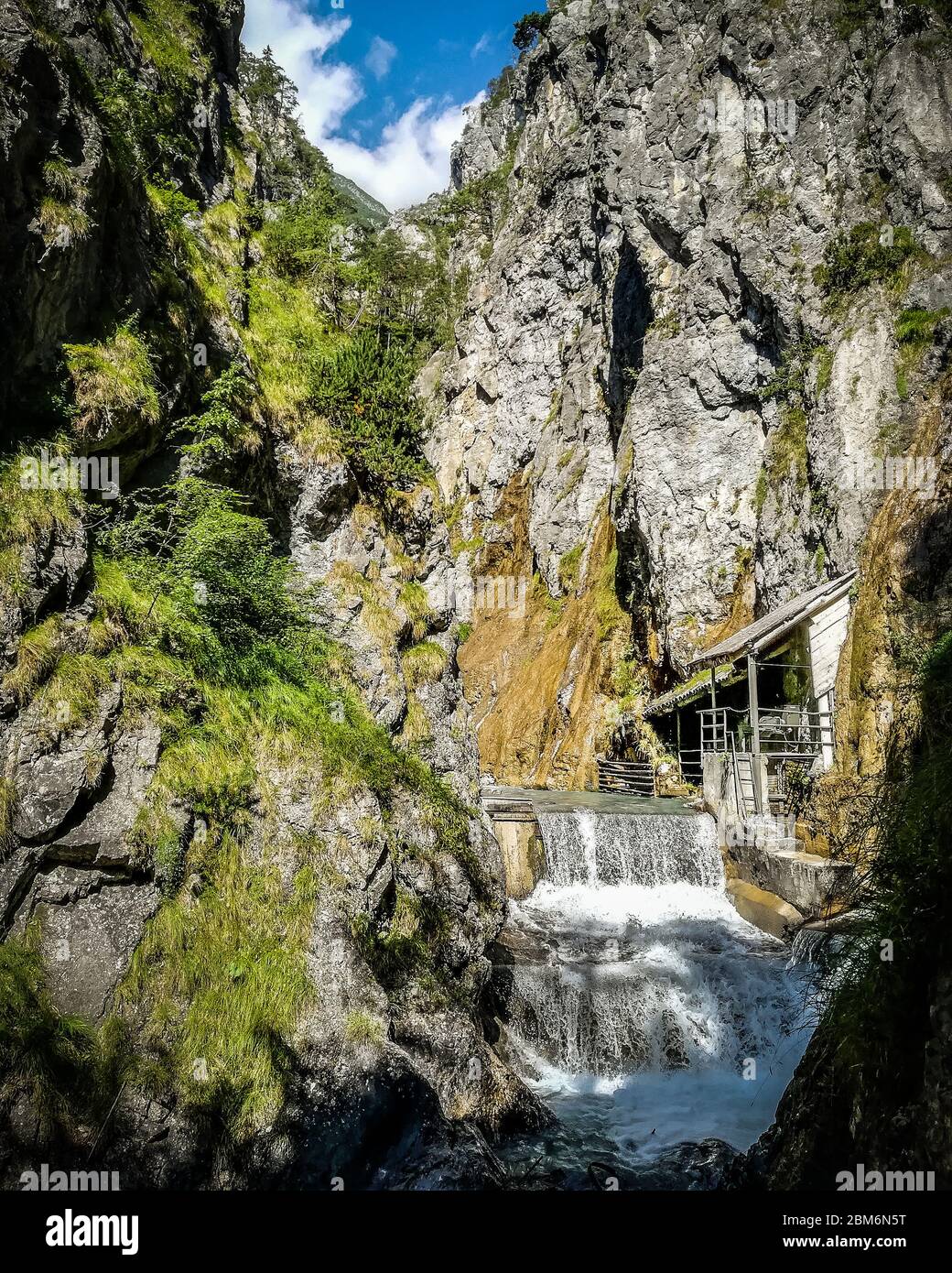 Surround mountain multiple cascade alpine waterfall old power station ...