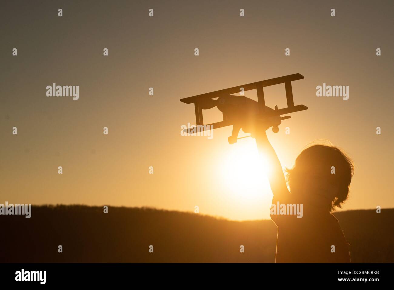 Kid child boy pilot aviator with airplane dreams of traveling in summer ...