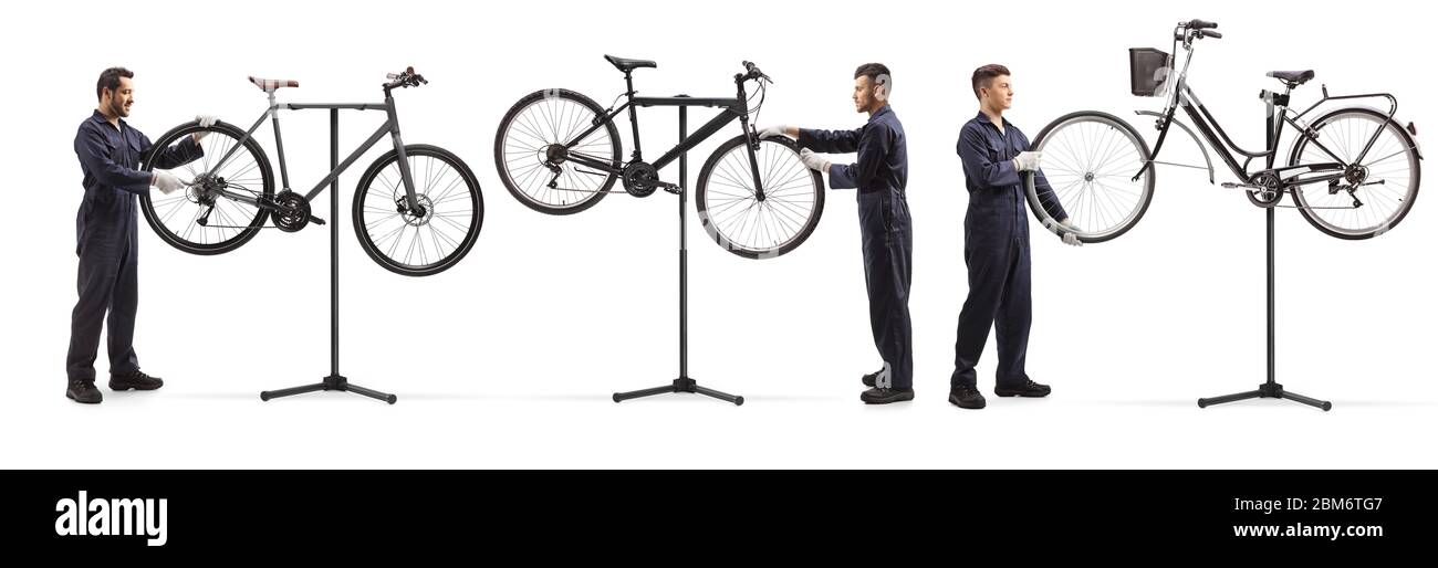 Men working in a bicycle repair workshop isolated on white background ...