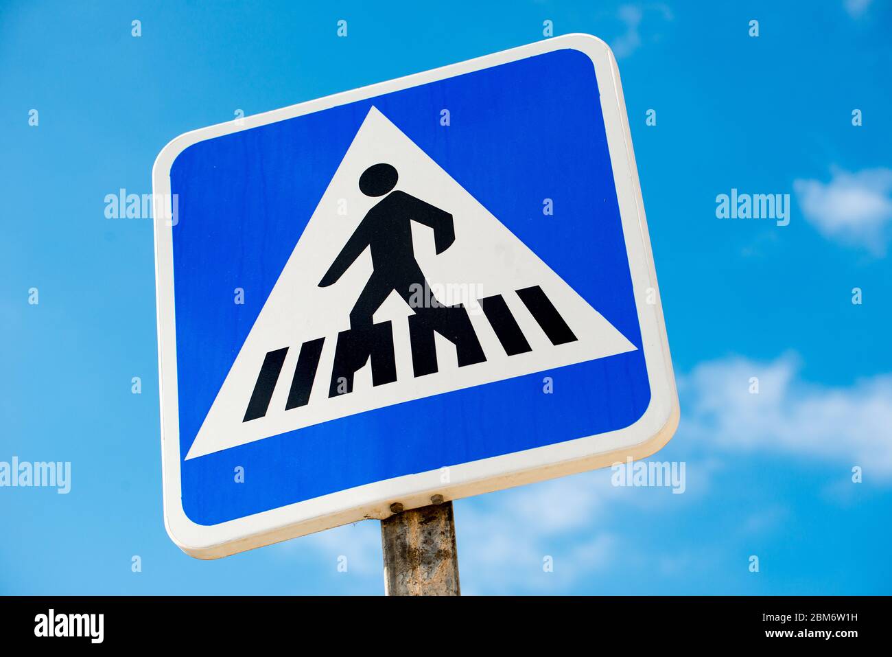 Low angle view of Spanish pedestrian crossing road sign, against a ...