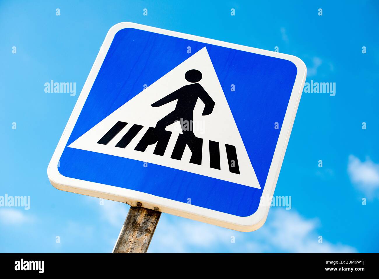Low angle view of Spanish pedestrian crossing road sign, against a ...