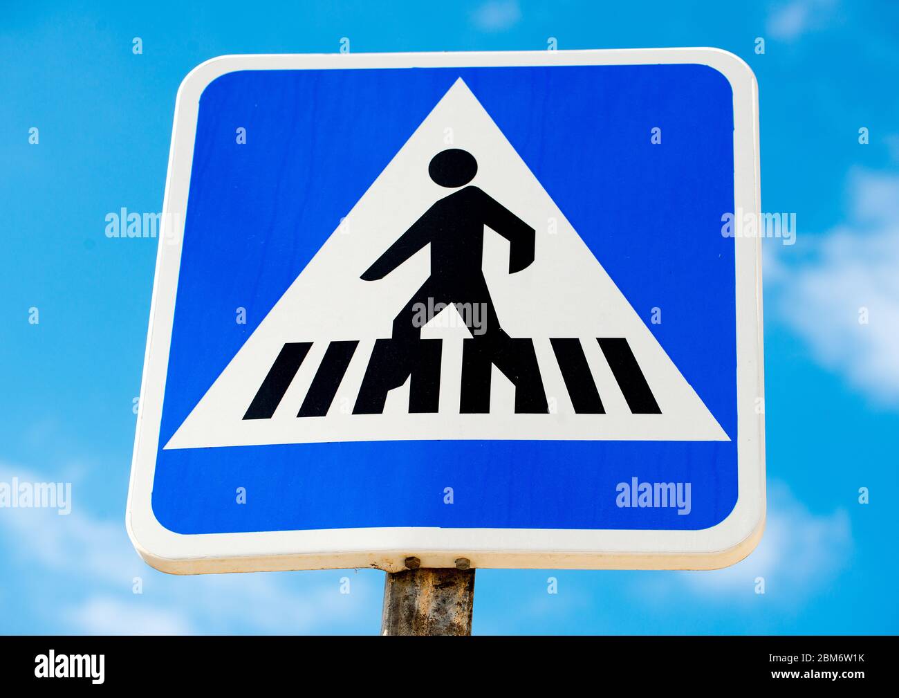 Low angle view of Spanish pedestrian crossing road sign, against a ...
