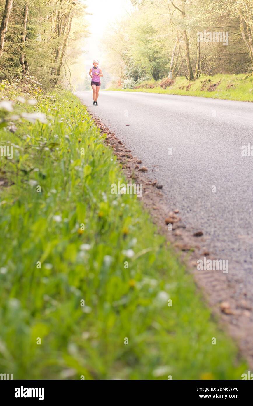 Woman running in a forest - daily activities to keep fit and healthy ...