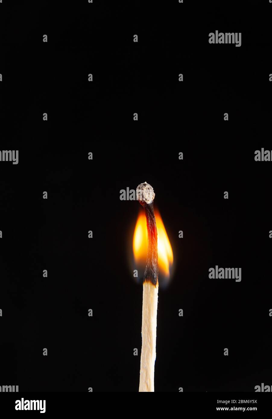 A burning matchstick on black background Stock Photo - Alamy