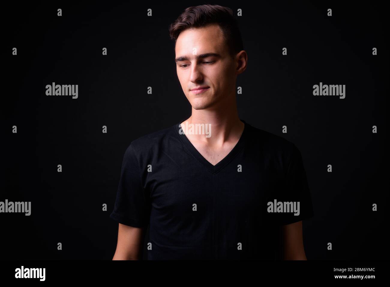 Stressed young man thinking and looking down Stock Photo - Alamy