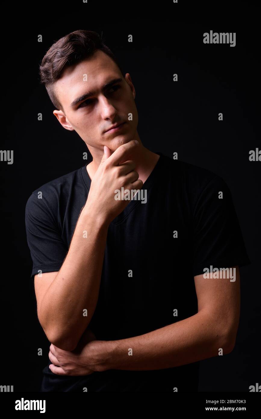Portrait of stressed young man thinking and looking away Stock Photo ...
