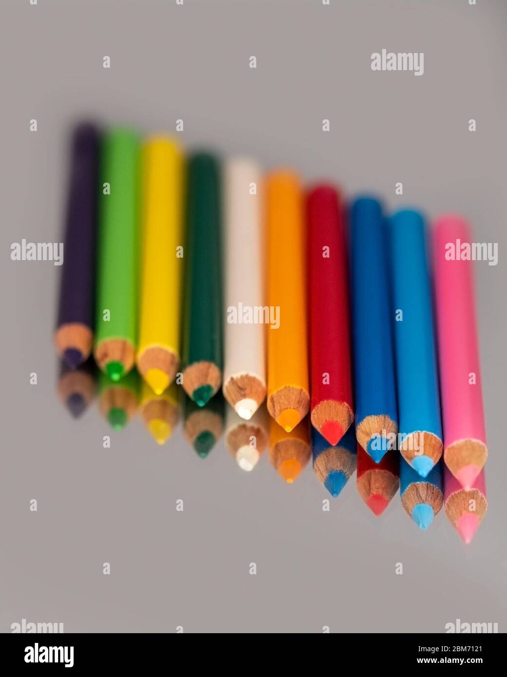 Set of colored pencils on mirror, reflected, back-to-school or adult ...