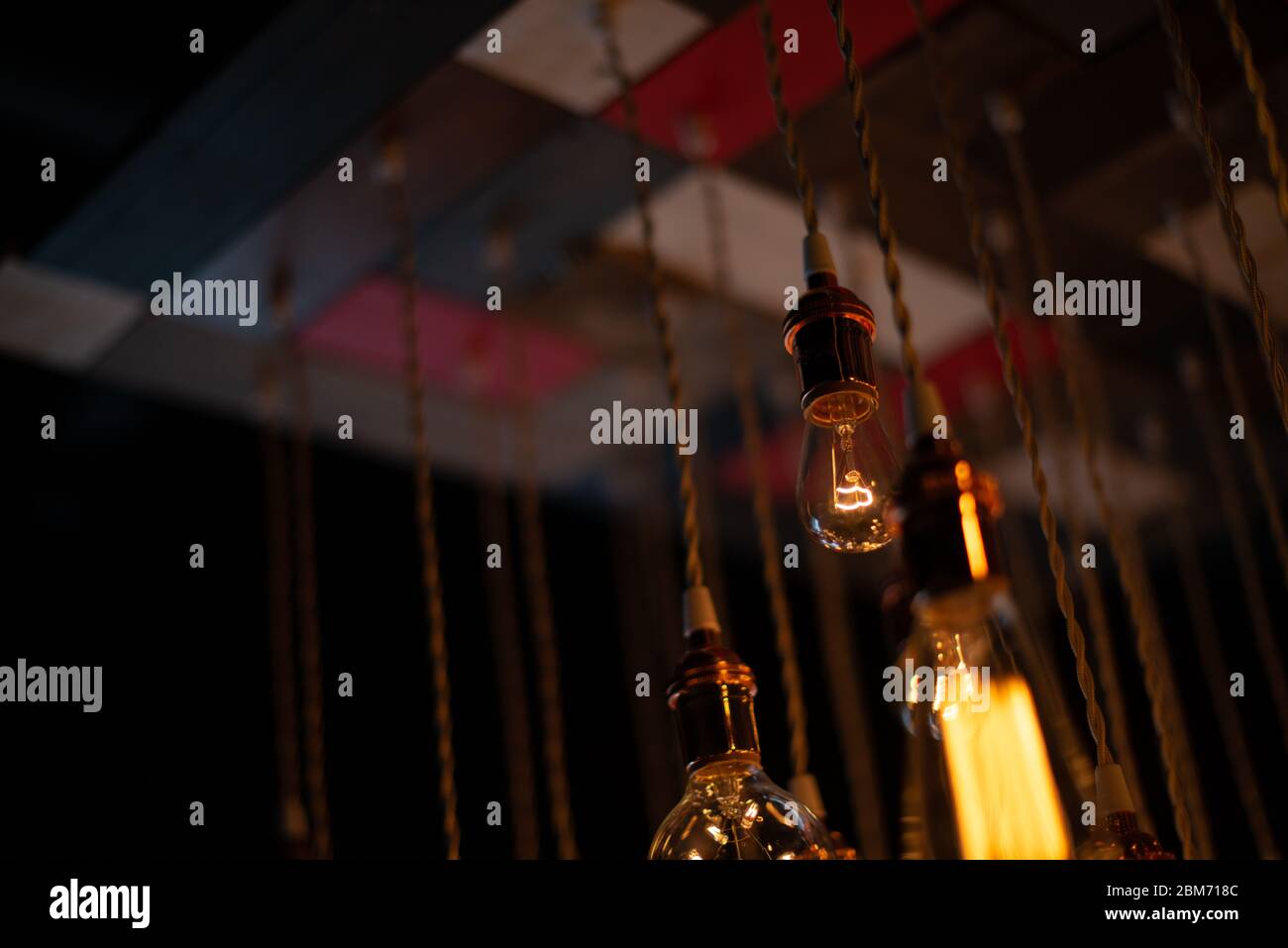 Hanging array of many incandescent light bulbs from ceiling Stock Photo ...