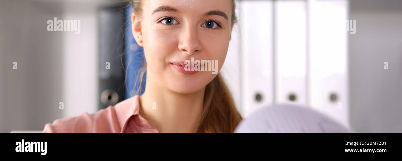 Girl in office analyzes and makes notes on report Stock Photo - Alamy