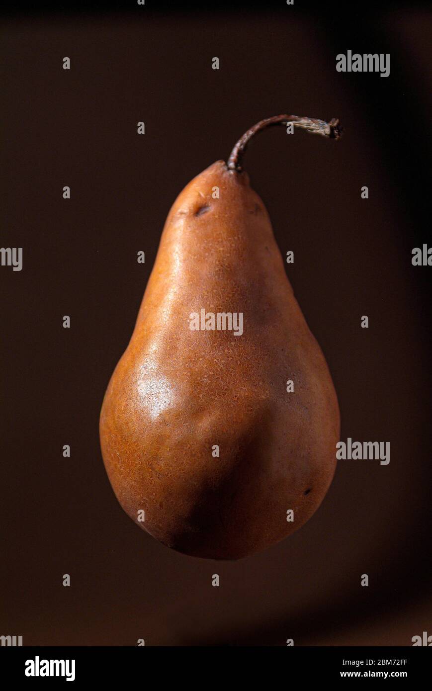 Fresh floating pear on brown background Stock Photo - Alamy