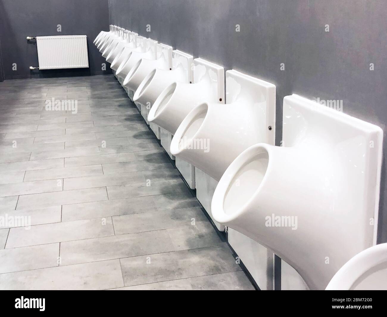 View of men's round shaped pipe urinals in a public toilet Stock Photo ...