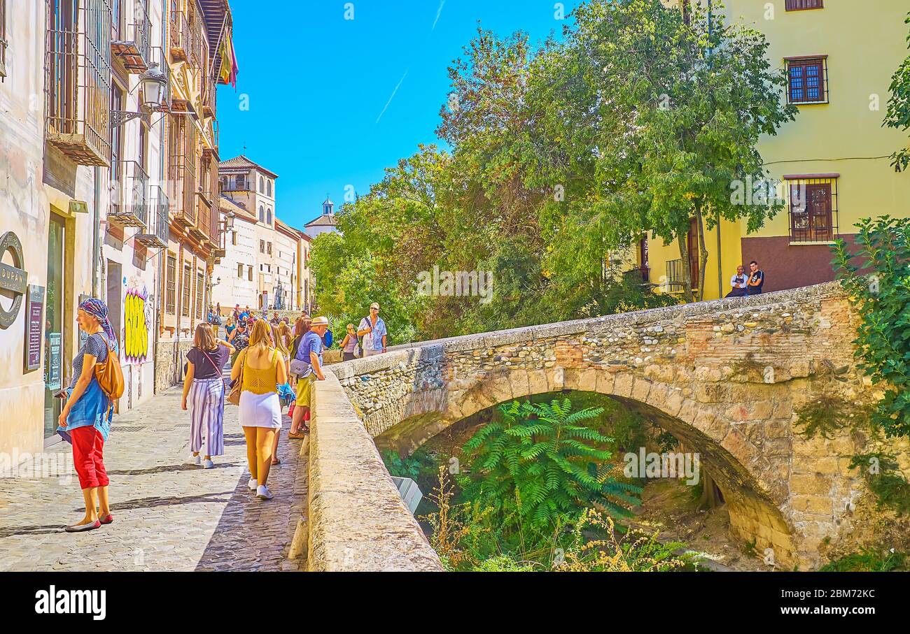 GRANADA, SPAIN - SEPTEMBER 25, 2019: People walk arched Puente Espinosa ...