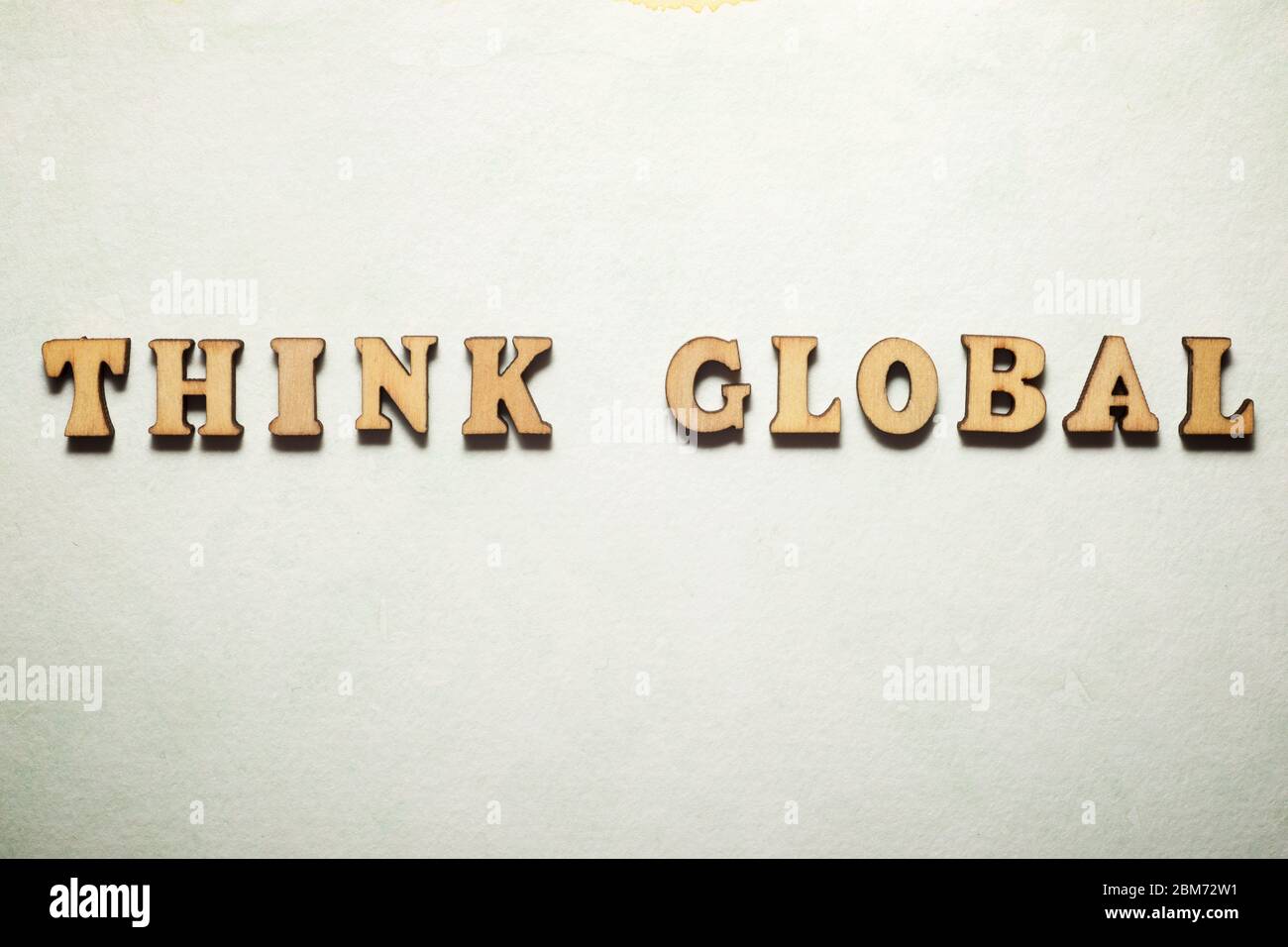 Think global text in a colored paper Stock Photo - Alamy